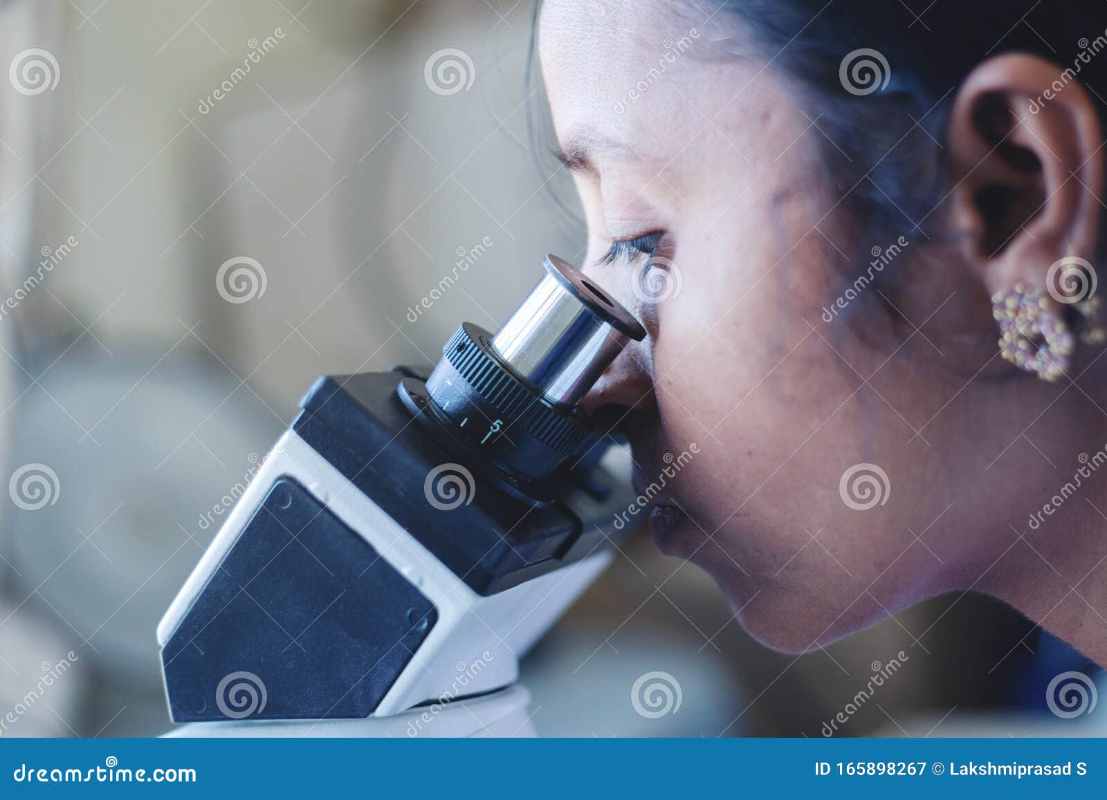 Close Up of Woman Using a Microscope in a Laboratory - Female Scientist ...