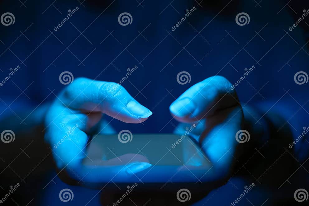 Close Up of Woman Using Mobile Phone with Blue Lighting Effect Stock ...