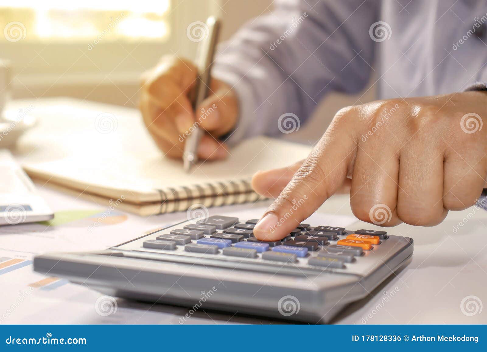 Close-up of Women Using a Calculator and Note-taking of Accounting ...