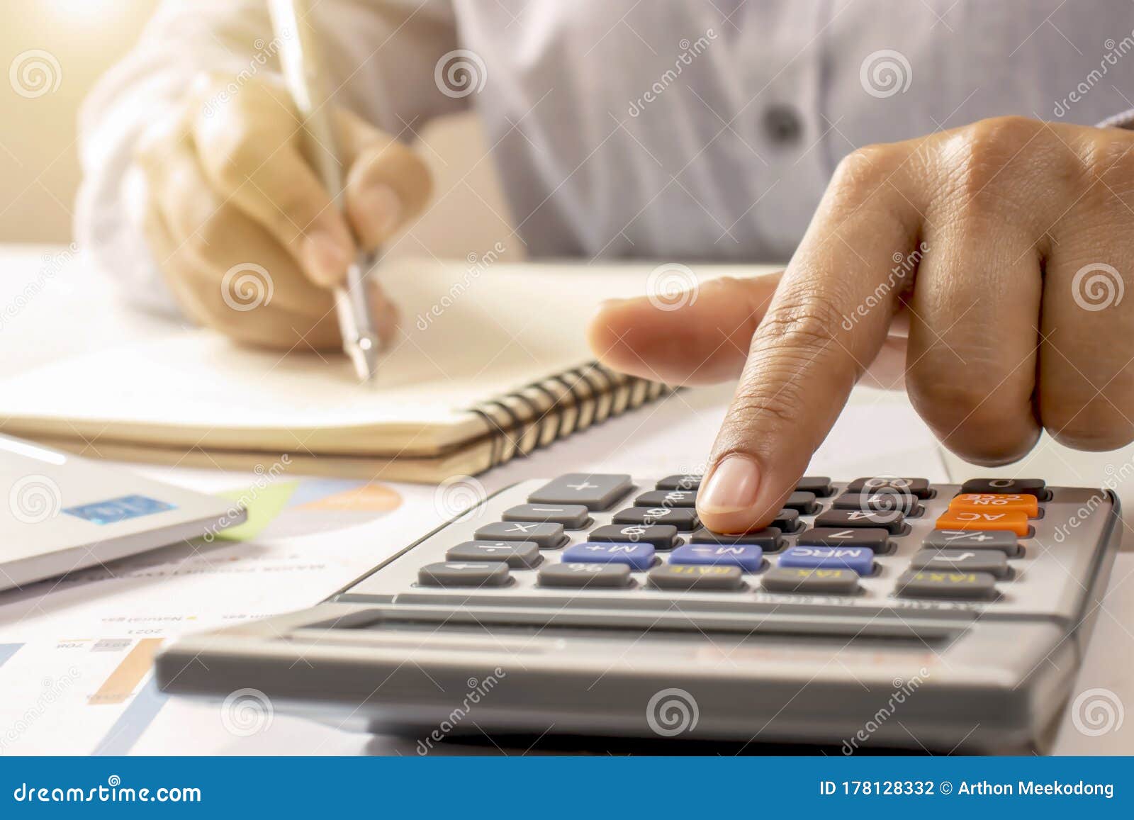 Close-up of Women Using Calculators and Note-taking, Accounting Reports ...