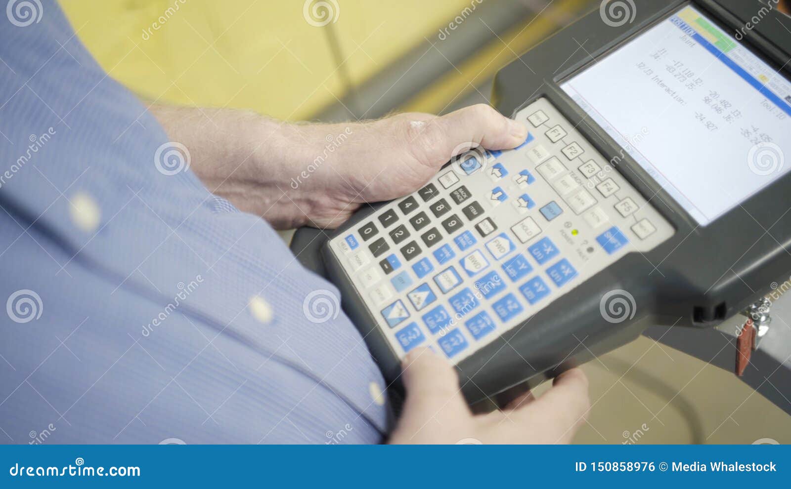 Close-up of Worker Holding Machine Control Panel in Factory. Action ...