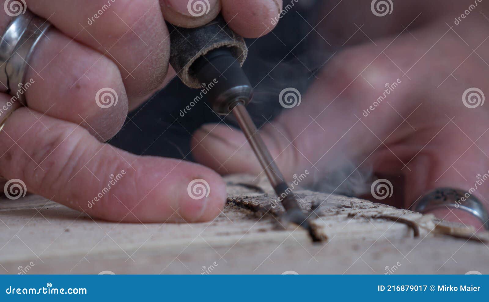 Close-up of Worker`s Hand with Tools Hacking Wood with Smoke that is ...