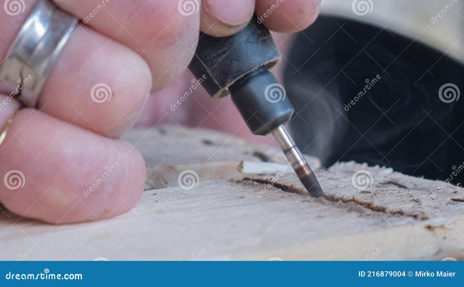 Close-up of Worker`s Hand with Tools Hacking Wood with Smoke that is ...