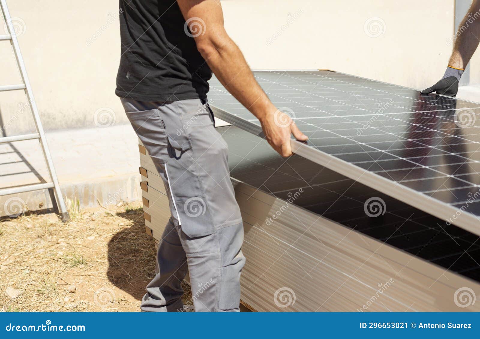 Close-up of a Worker S Hands Tying a Stack of Solar Panels with Orange ...