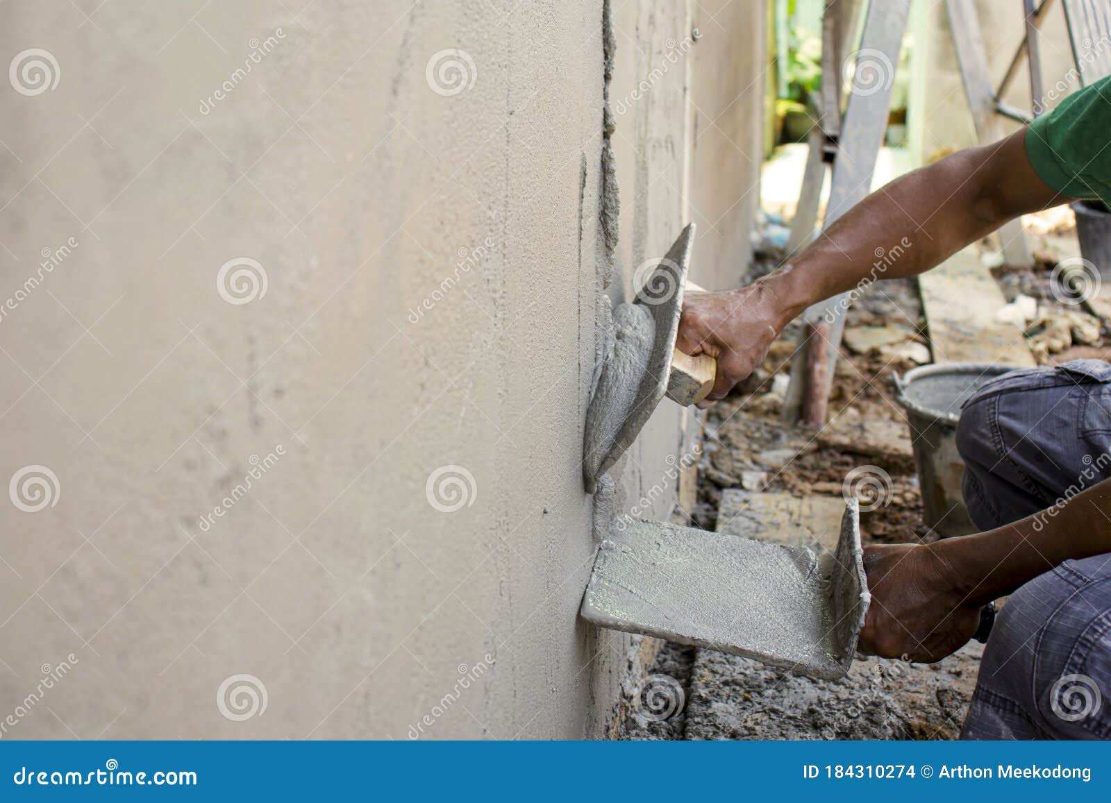 Close-up of Workers Using Plaster Trowel To Plaster the Walls for House ...