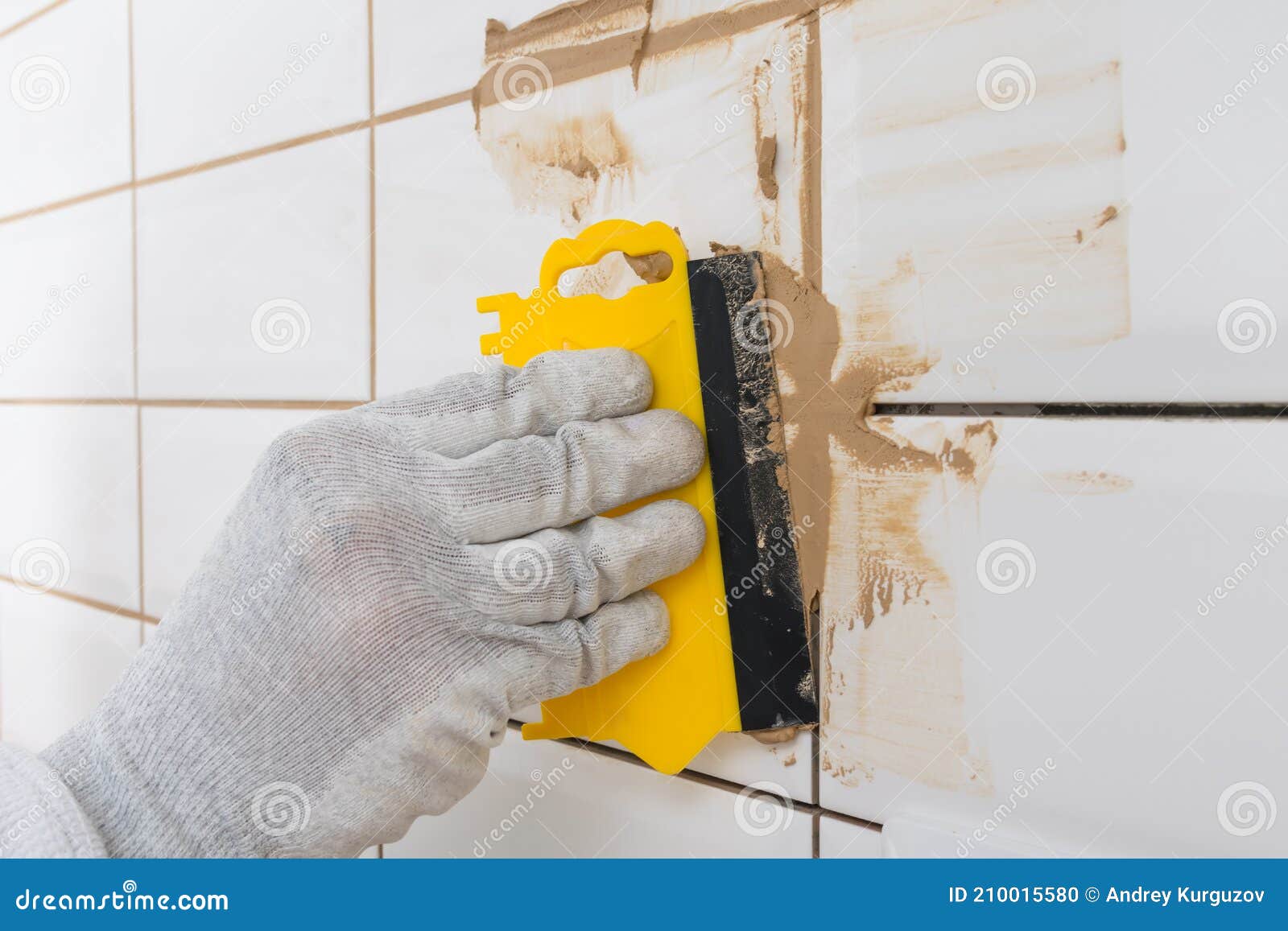 Close-up of a Yellow Trowel, in the Process of Grout of a White Tile ...