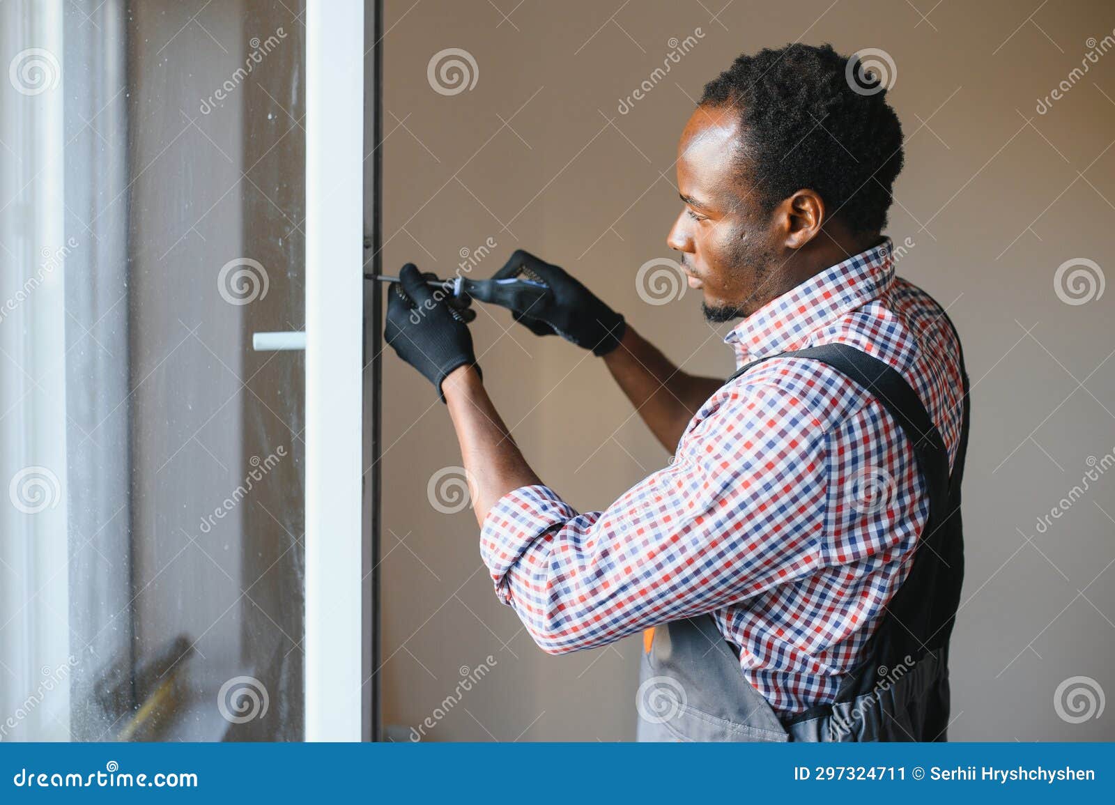 Close-up of Young African Handyman in Uniform Installing Window Stock ...
