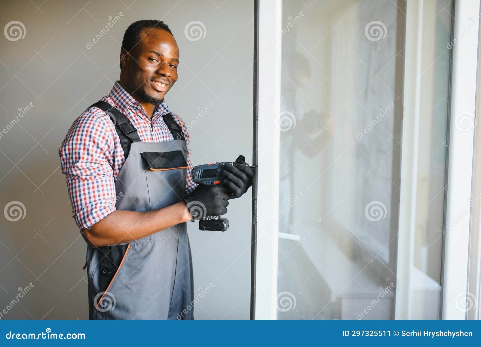 Close-up of Young African Handyman in Uniform Installing Window Stock ...