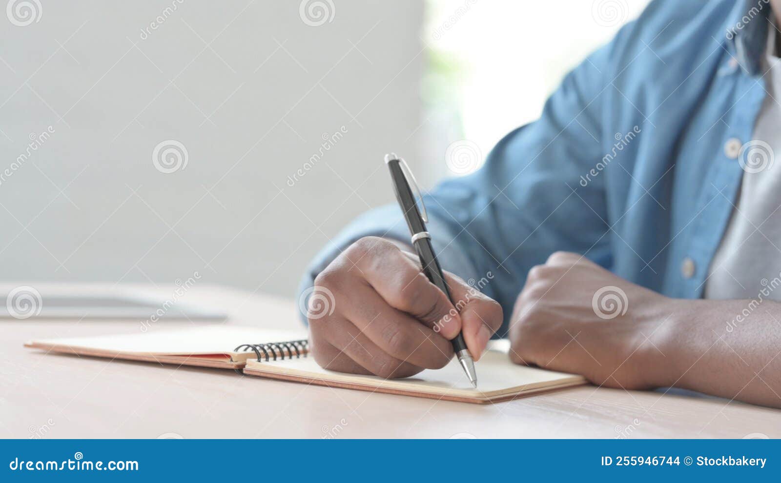 Close Up of Young African Man Writing on Notebook Stock Photo - Image ...