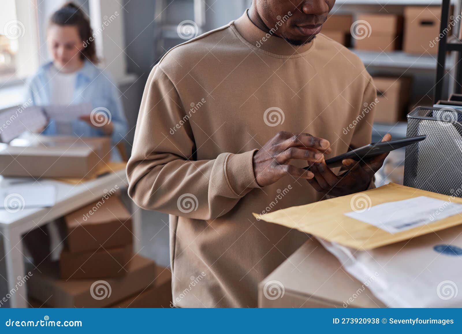 Close-up of Young Black Man Checking Data in Tablet in Post Office ...