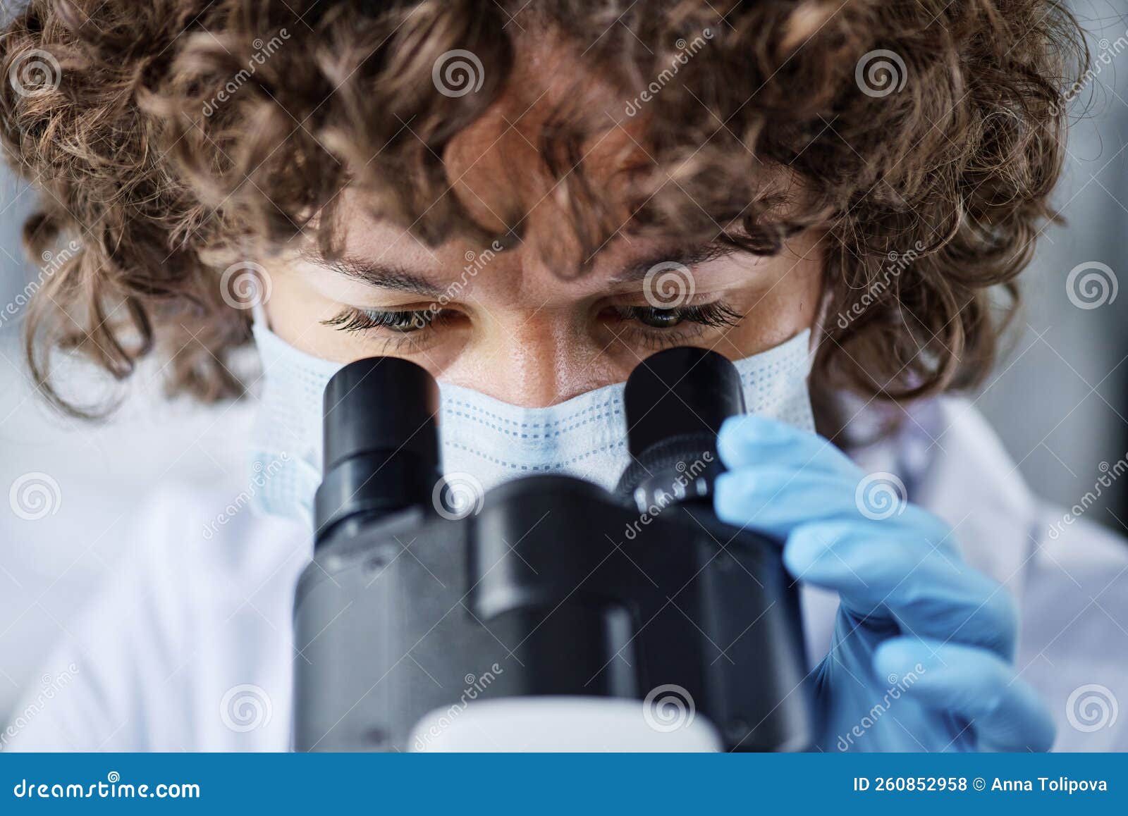Close-up of Young Female Microbiologist in Protective Mask during Trial ...