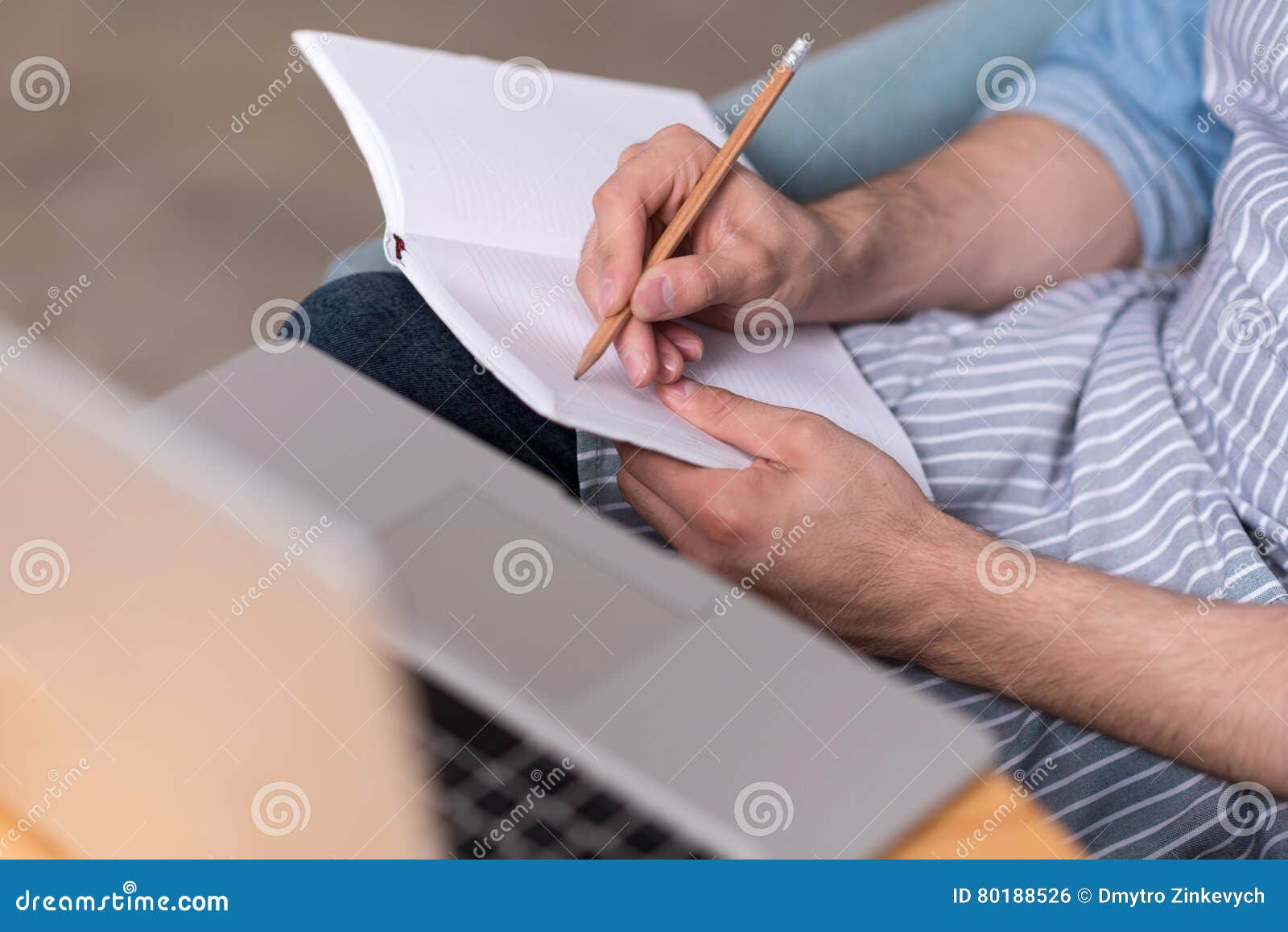 Close Up of Young Man Making Notes by the Laptop. Stock Photo - Image ...