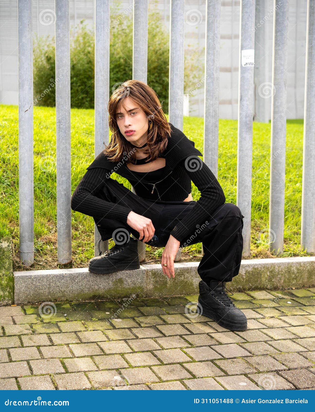 Close-up of Young Man Posing in a Crouch Looking Straight at the Camera ...