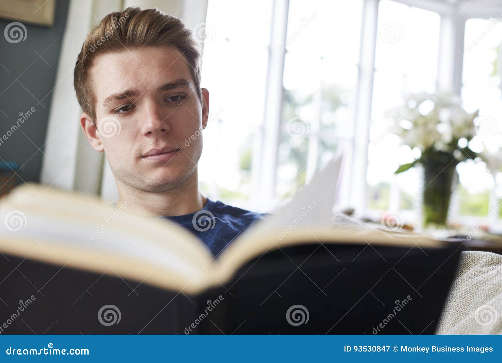 Close Up of Young Man Reading Book at Home Stock Image - Image of view ...