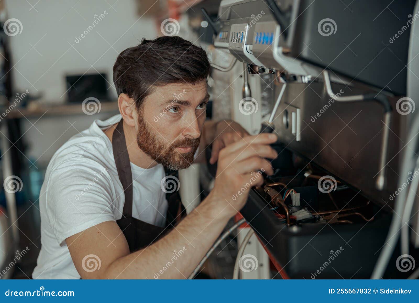 Close Up of Young Man Repairing Coffee Machine Using Screwdriver in a ...