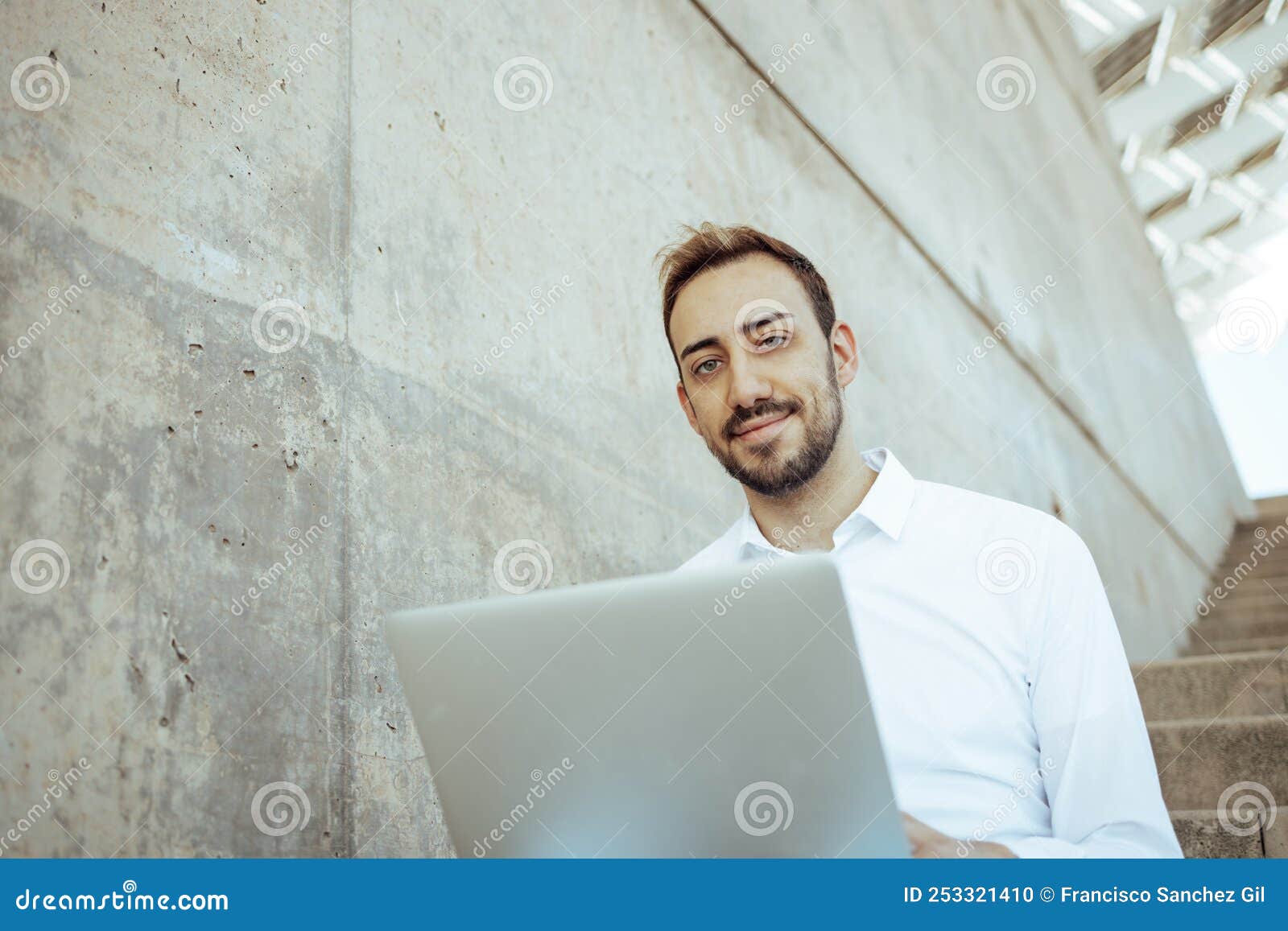 Close-up of Young Man Smiling with Computer Looking at the Camera Stock ...