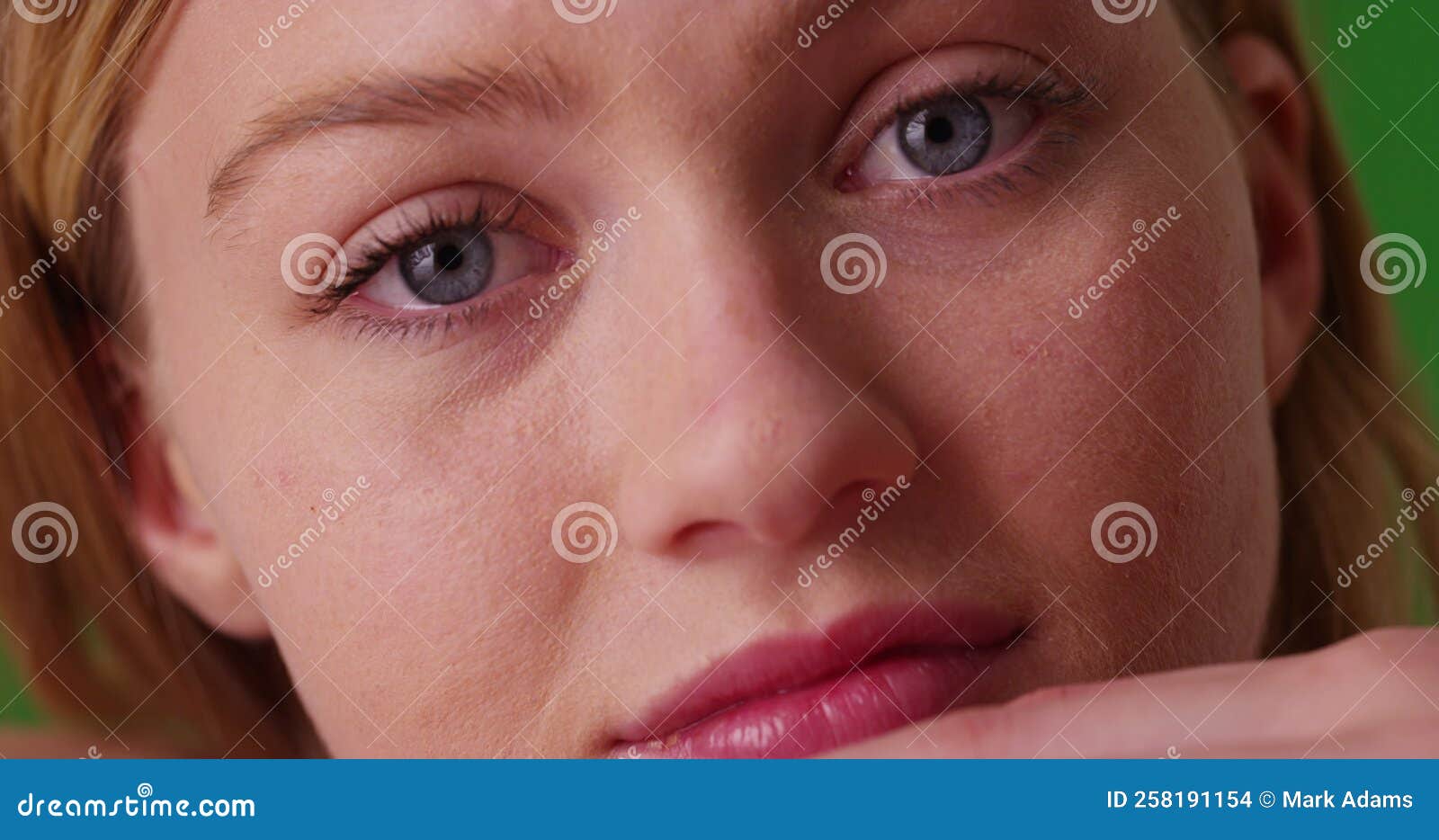 Close Up Of Young Millennial Caucasian Woman Looking Into Camera On
