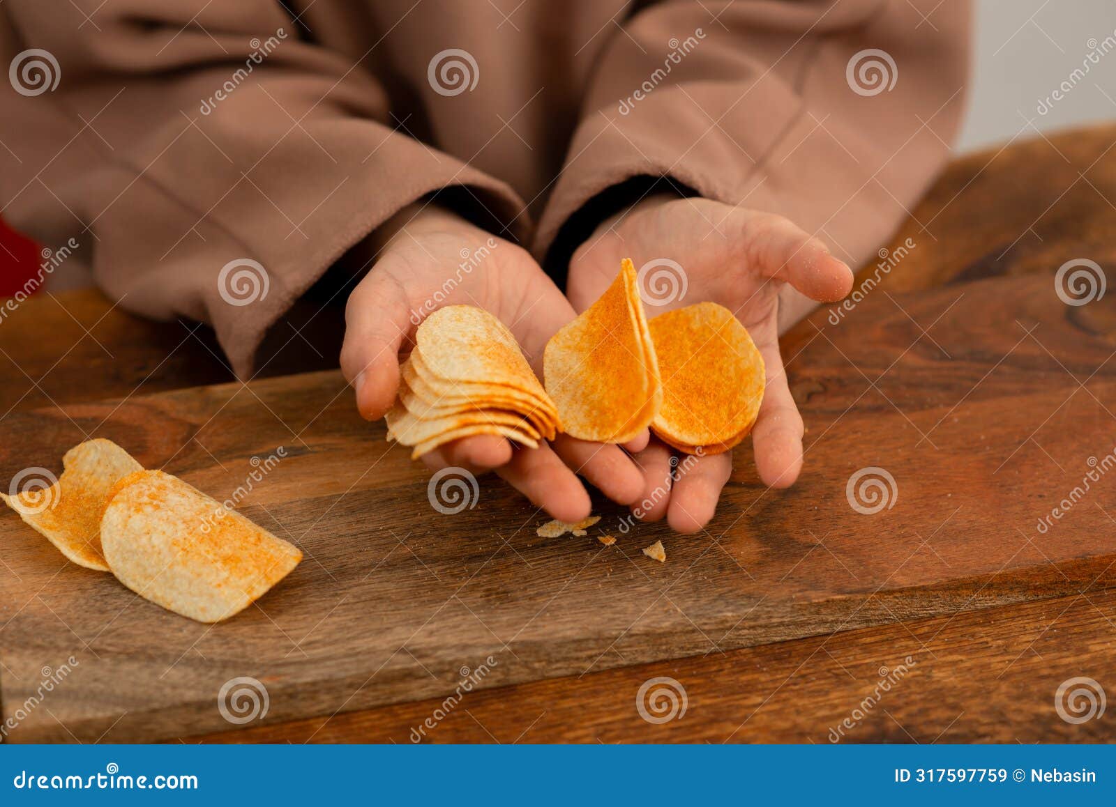 A Close View of a Hand Picking a Chip from a Spread of Chips on a Table ...