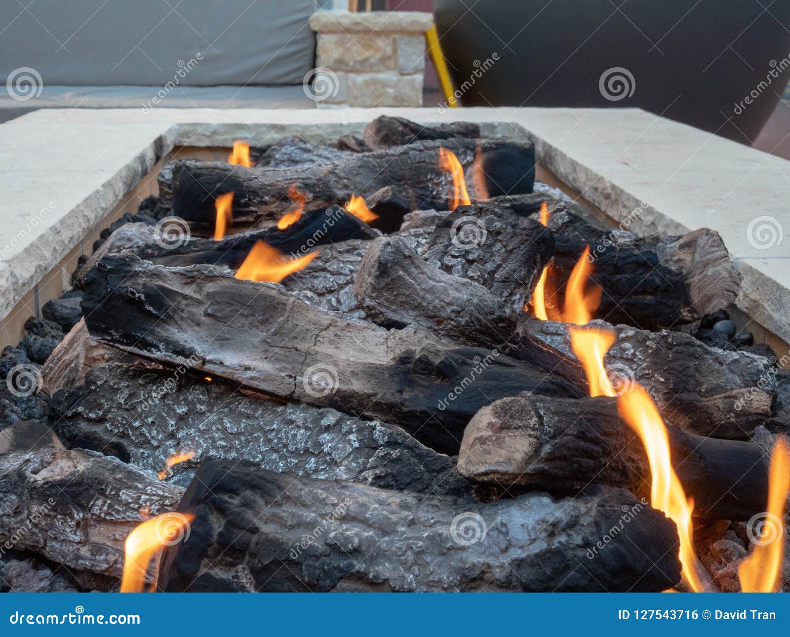 Close Up of Logs Burning in a Large, White, Stone Fire Pit Stock Photo ...