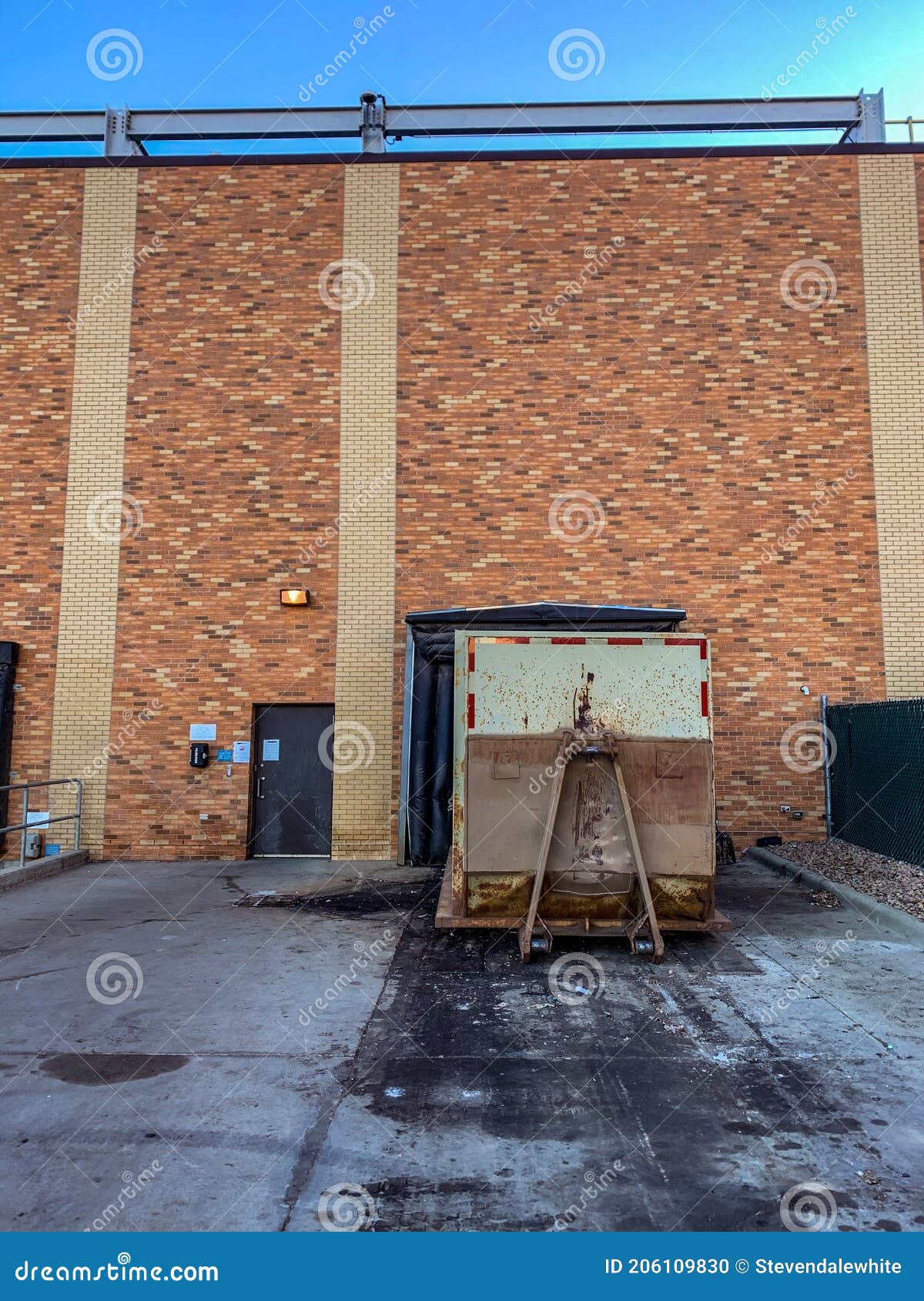 Closed Bay Doors and Garbage Roll-offs Outside an Industrial Complex ...