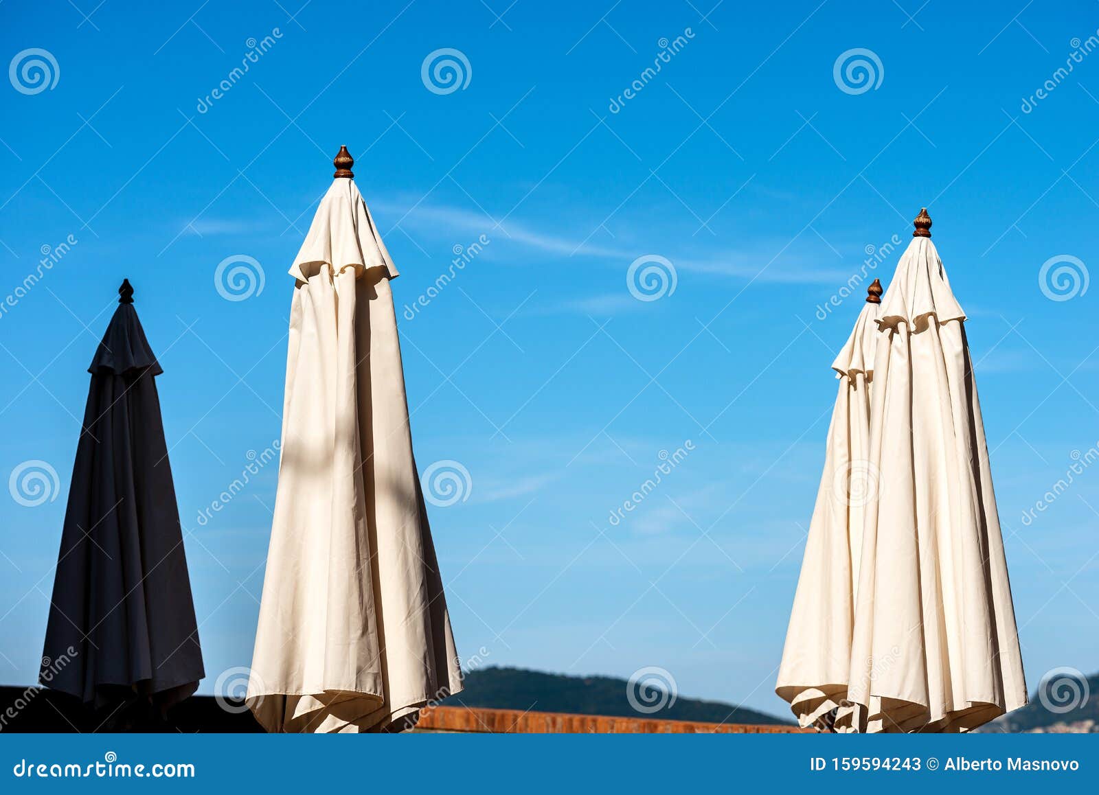 Closed Beach Umbrellas on Blue Sky Stock Image - Image of close ...