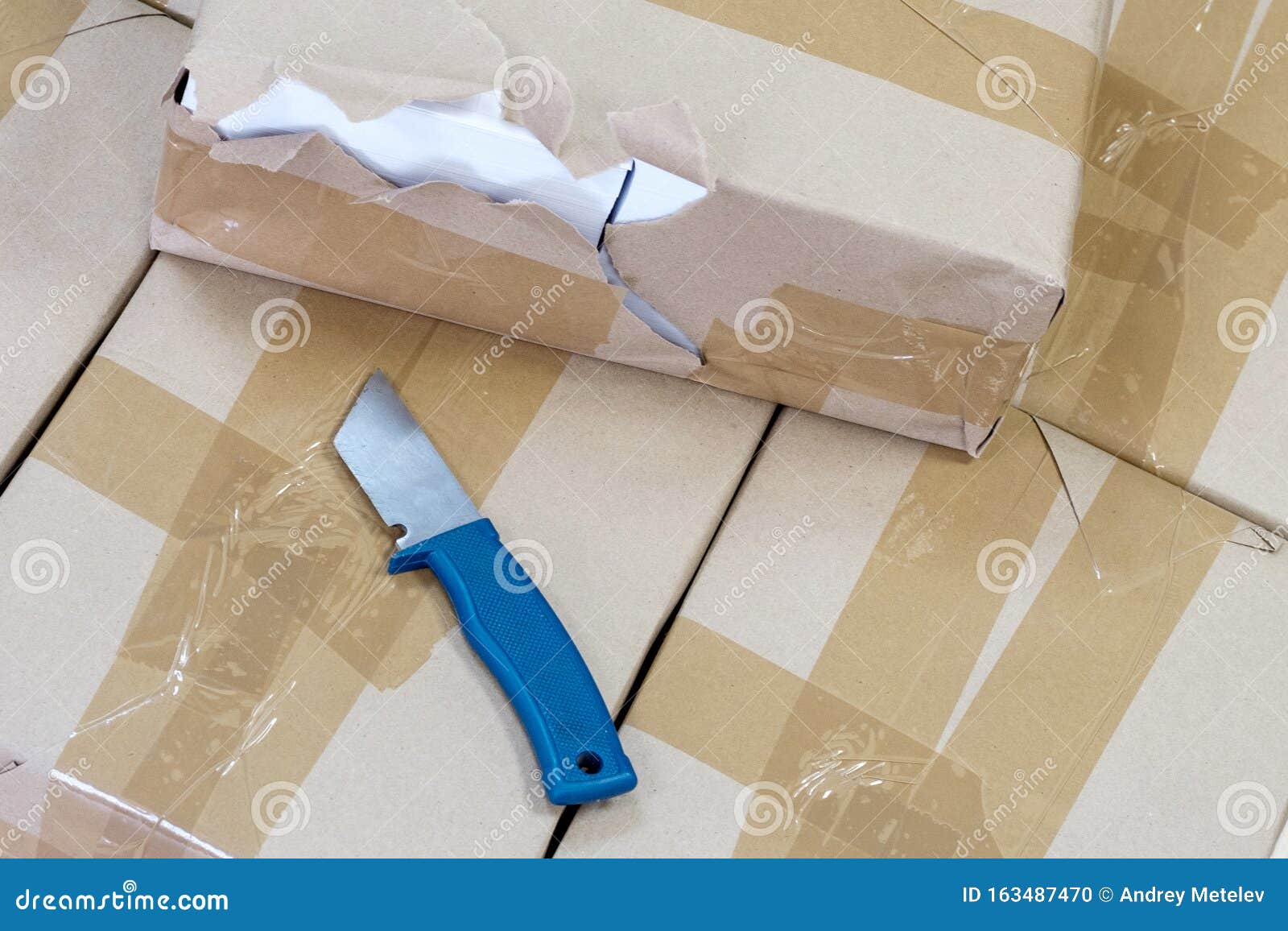 Closed Boxes with Parcels and a Knife for Opening Boxes Stock Photo ...