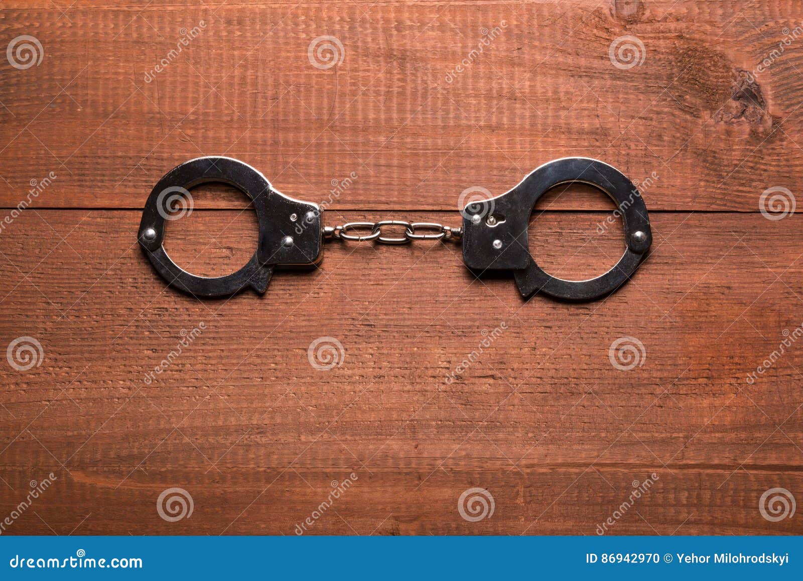 Closed Handcuffs on a Wooden Table Stock Photo - Image of order, legal ...