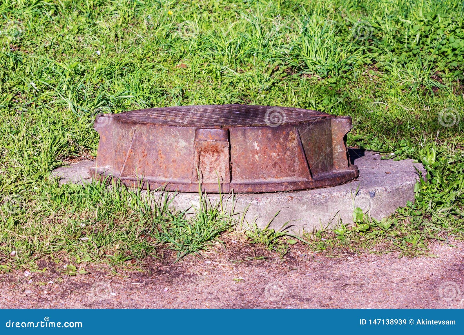 Closed Hatch with a Concrete Base on the Green Grass in Bright Sunlight ...