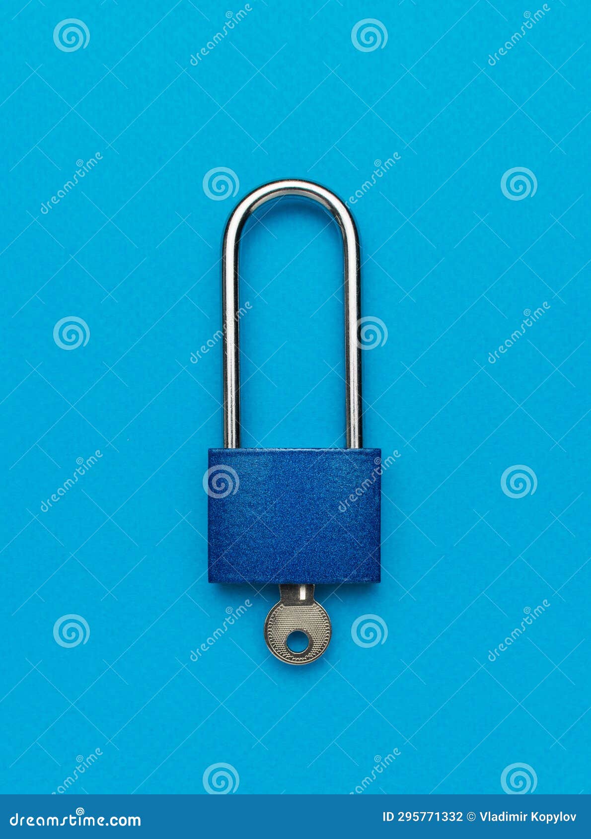 A Closed Metal Lock with a Key on a Blue Background Stock Photo - Image ...