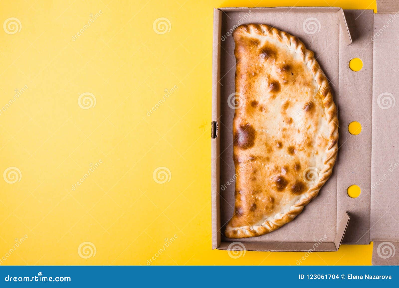 Closed Pizza Calzone in Packing Box on Yellow Background Stock Photo ...