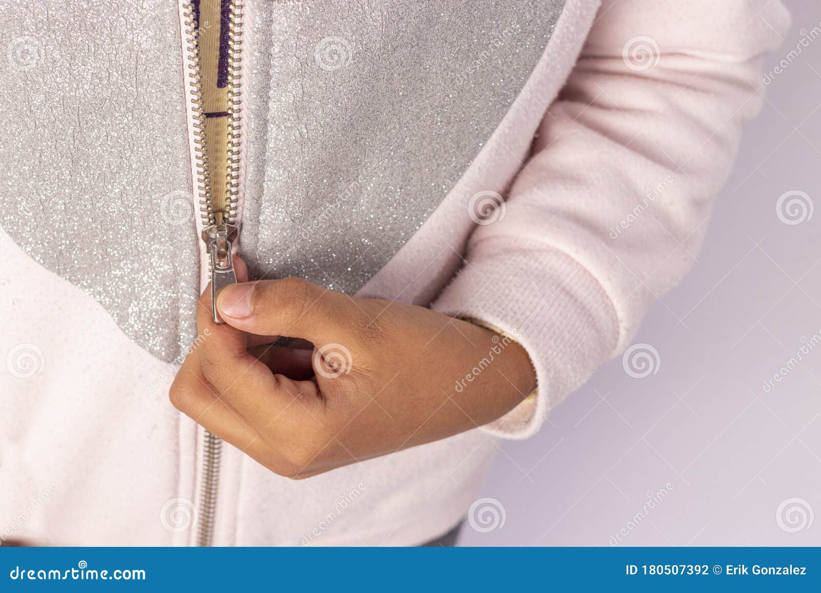 Closed Shot of a Hand Pulling Up the Closure of a Sweater Stock Photo ...
