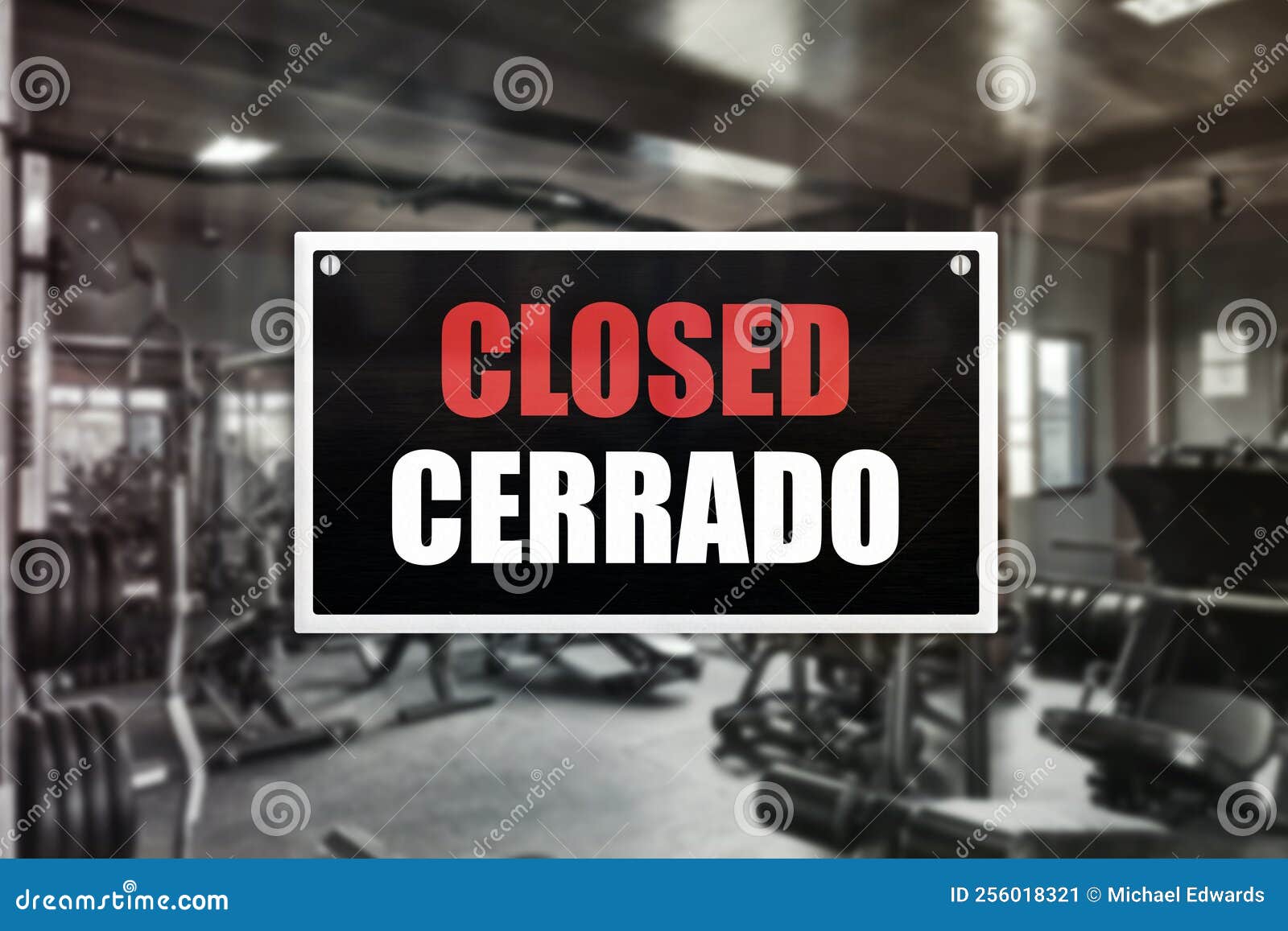 A Closed Sign with Spanish Translation in Front of a Gym Stock Image ...