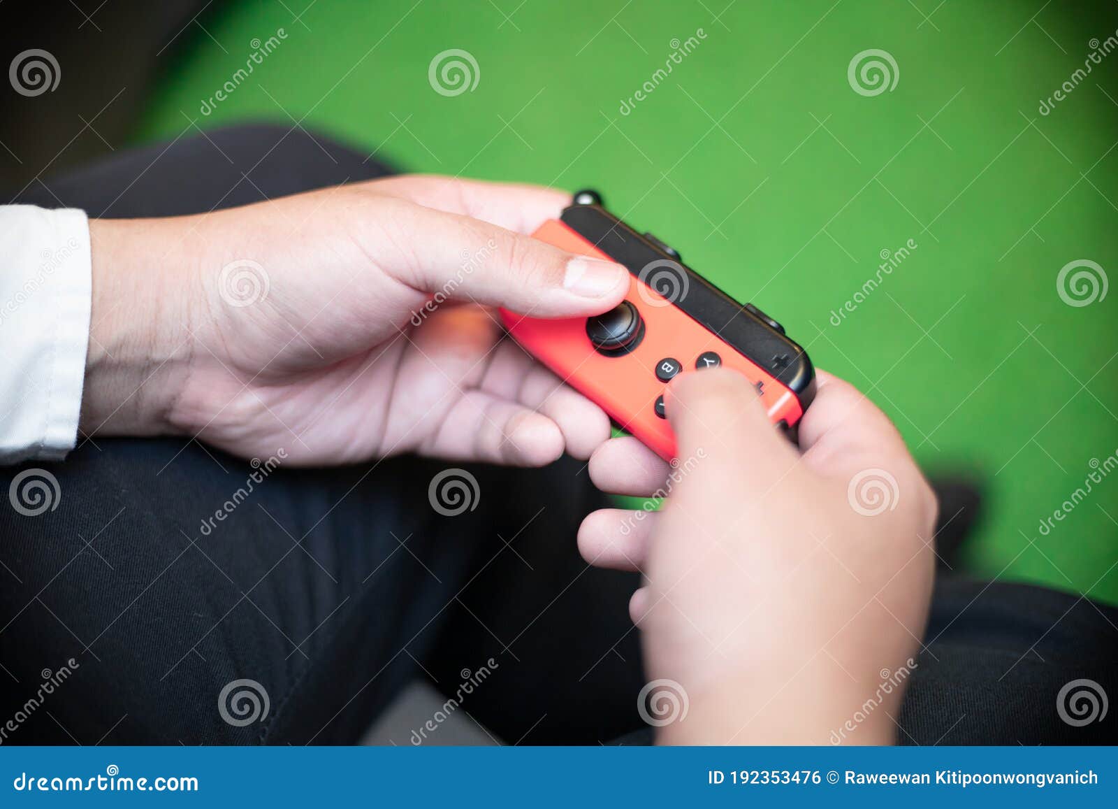Closed Up of Guy`s Hands Playing on the Red Game Console. a Wireless ...