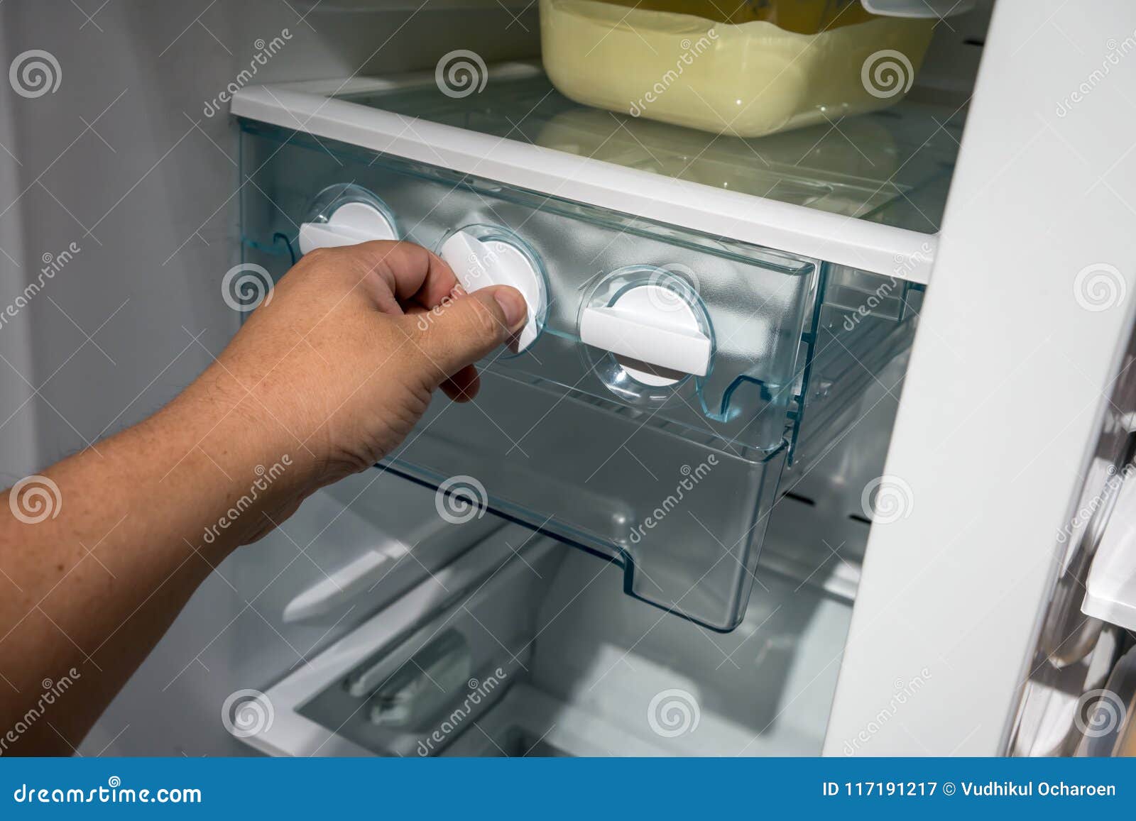 Closed Up Man Hand Twisting for Ice from the Ice Maker in Refrigerator ...