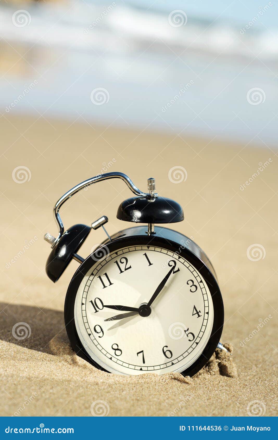 Alarm clock on the beach stock photo. Image of back - 111644536