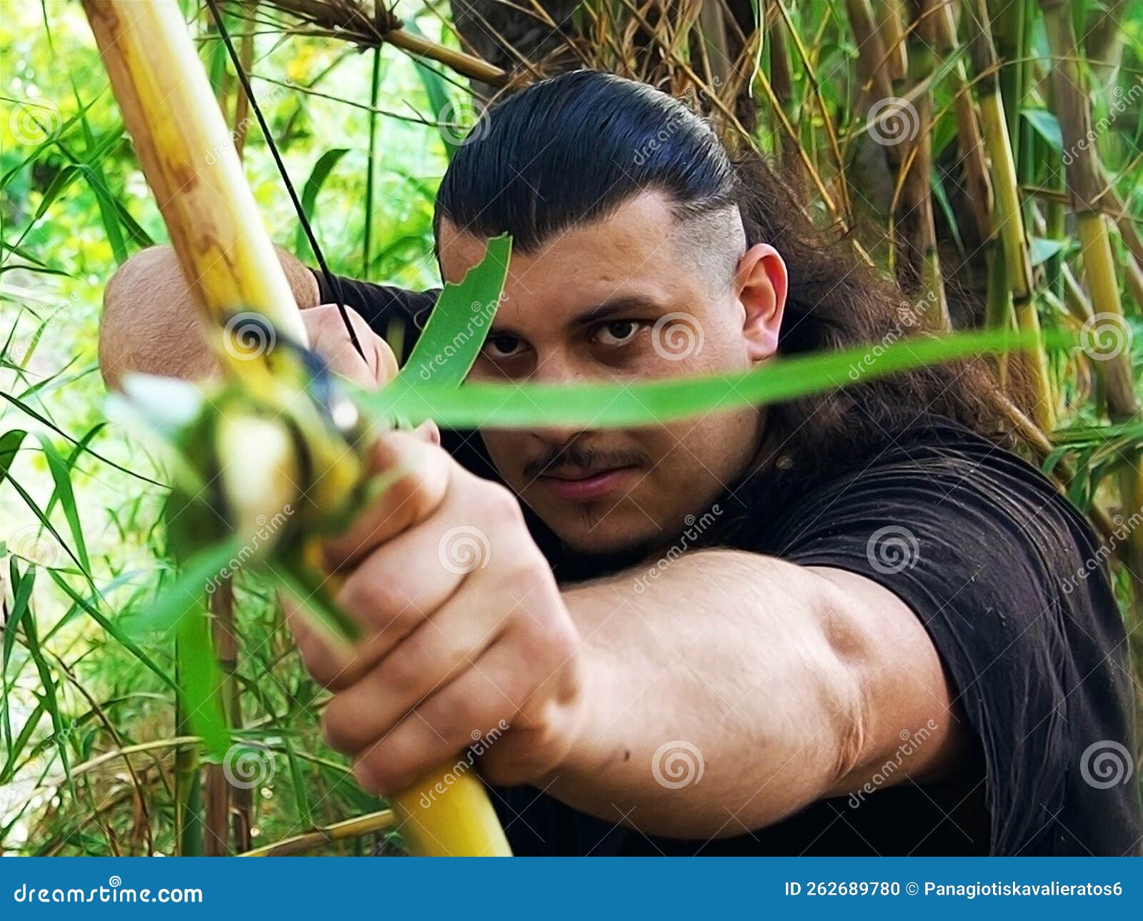 Closeup of an Archer Aiming at the Camera with a Menacing Expression ...