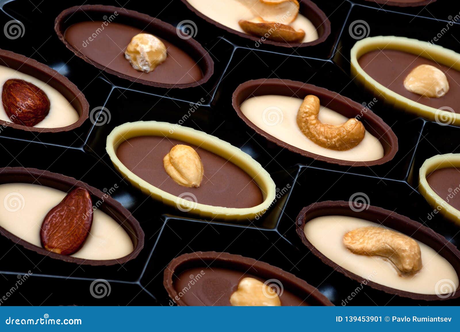 Closeup of Assorted Chocolates with Peanut, Cashew, Hazelnut and Almond ...