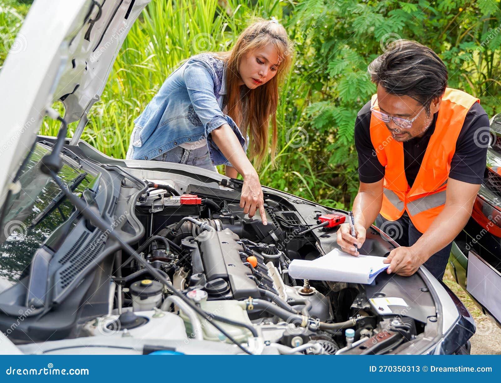 Closeup Auto Mechanic Checking for Breakdowns and List Repairs ...