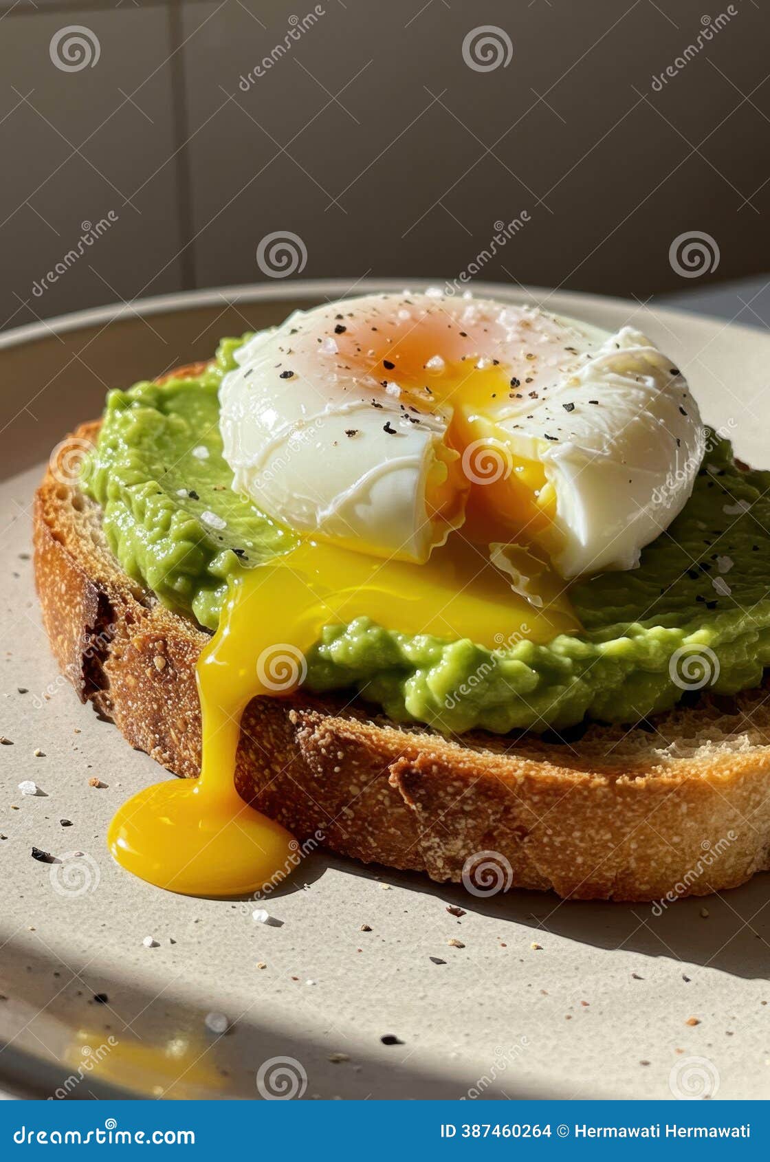 A Poached Egg With Runny Yolk On A Slice Of Toast Served On A Plate ...