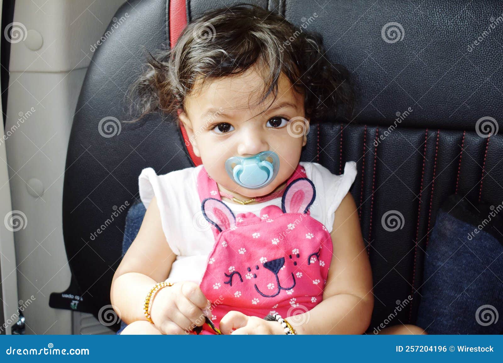 Closeup of a Baby with a Pacifier Looking at the Camera Stock Photo ...