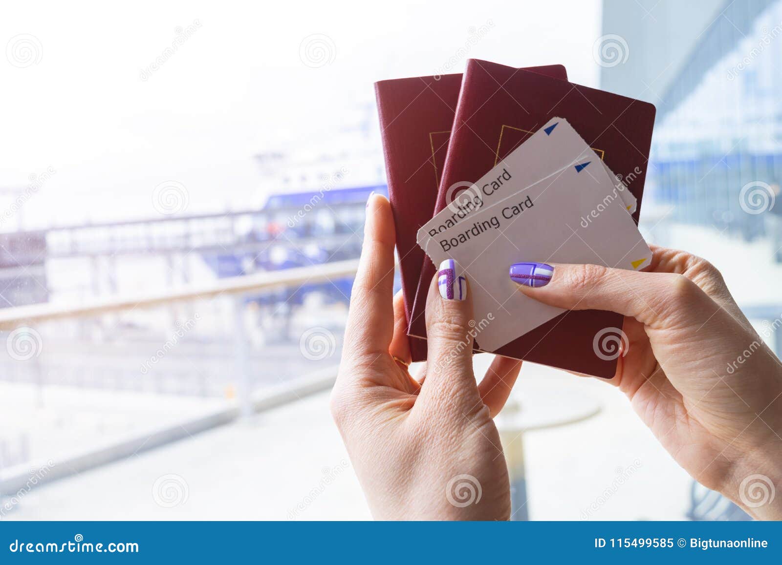 Closeup Of Beautiful Woman Hand Holding Passports And Boarding Pass