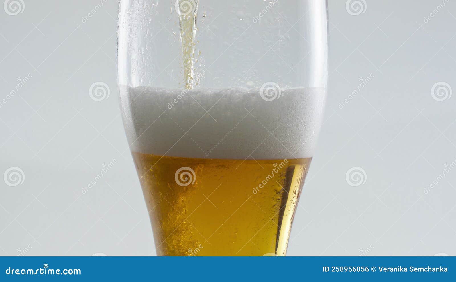Closeup Beer Pouring Glass Making Tasty Dense Foam At White Background