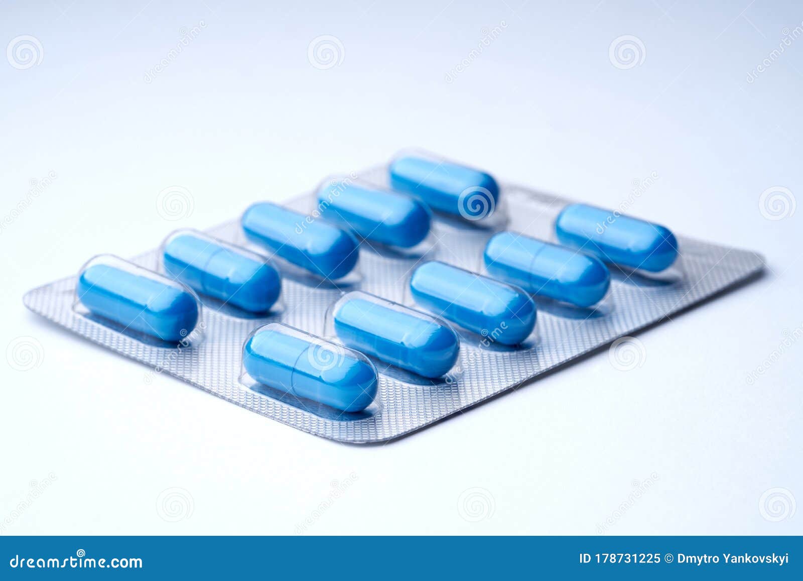 Closeup of Blue Pills in Packaging on a White Background with Texture ...
