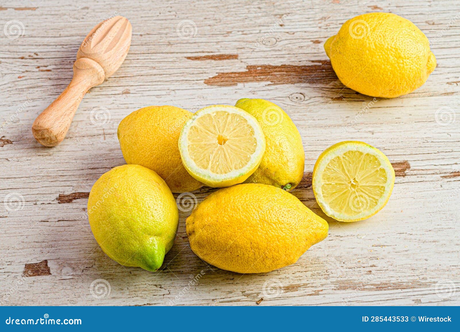 Closeup of Bright Yellow Lemons on a Wooden Surface Under the Natural ...