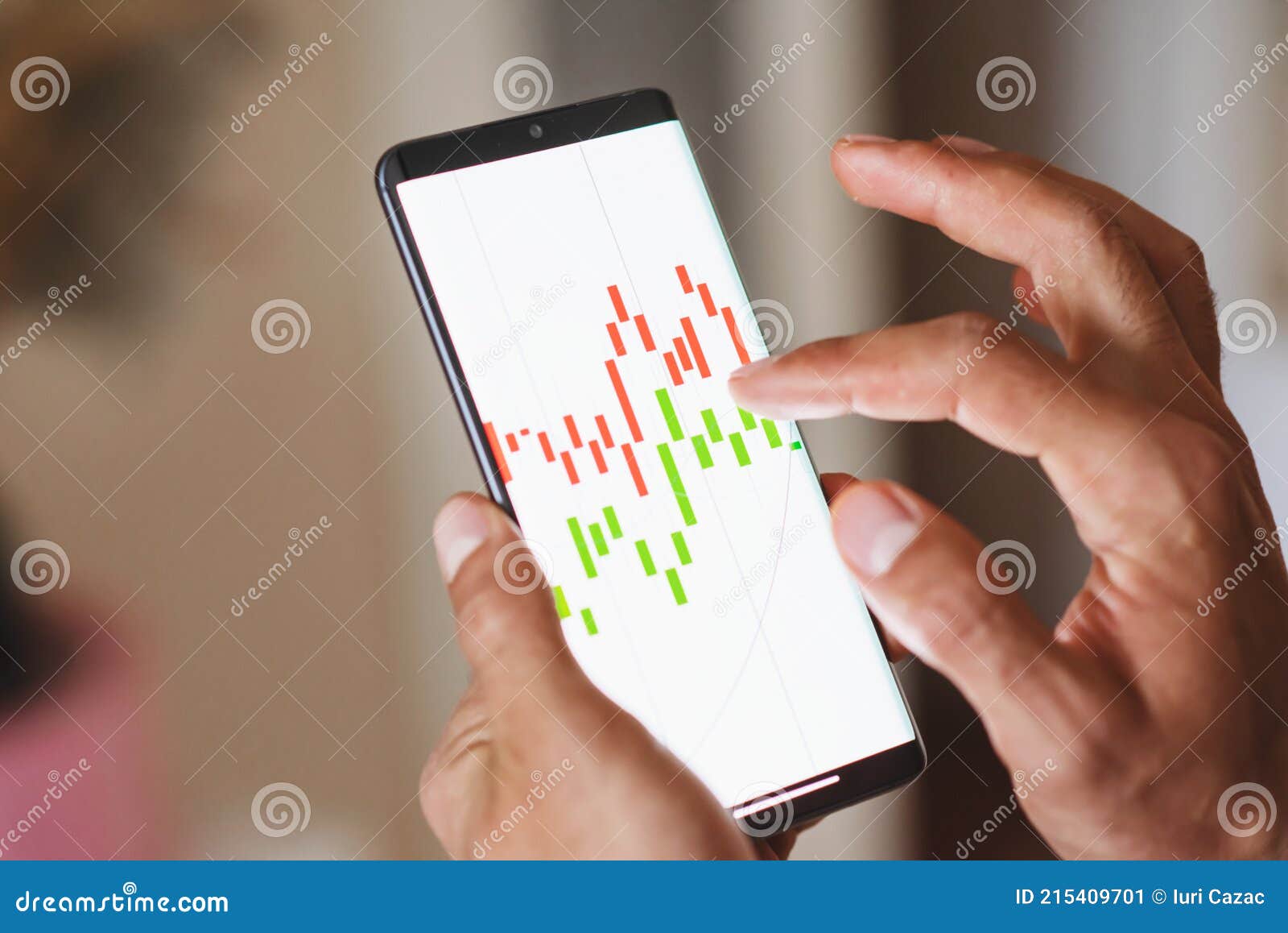 Closeup of a Broker Using a Mobile Phone with a Graph on a Touchscreen ...
