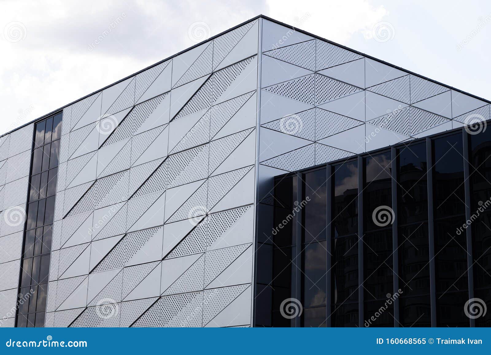 Close-up of Building with Triangular Pattern and Round Openings on Wall ...