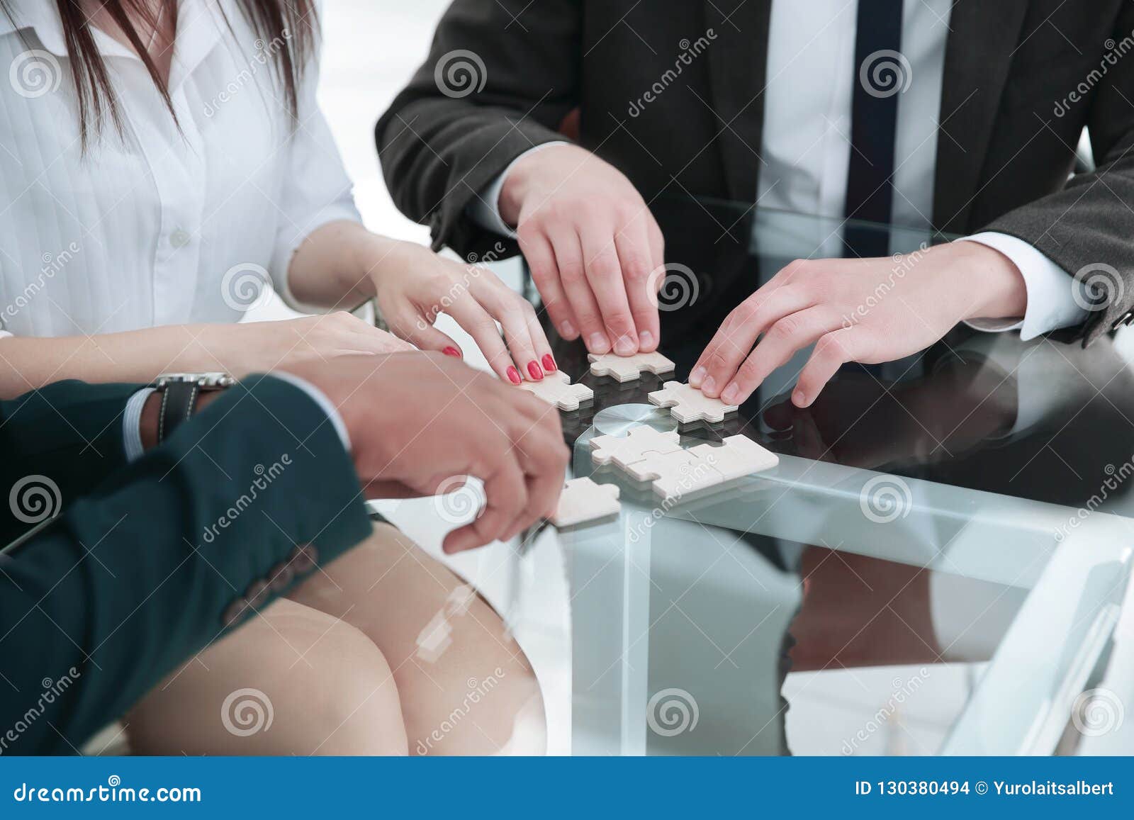 Closeup .business Team Assembling Puzzle Sitting Behind a Desk Stock ... Closeup .business Team Assembling Puzzle Sitting Behind a Desk Stock ...