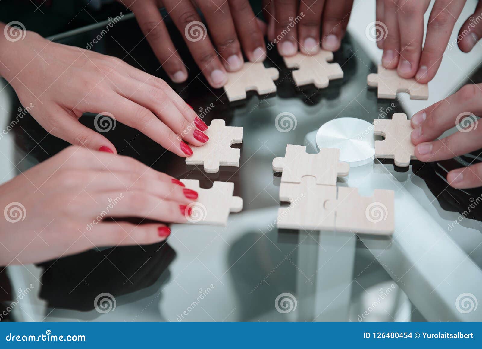 Closeup.business Team Assembling Puzzle,sitting at the Table Stock ... Closeup.business Team Assembling Puzzle,sitting at the Table Stock ...