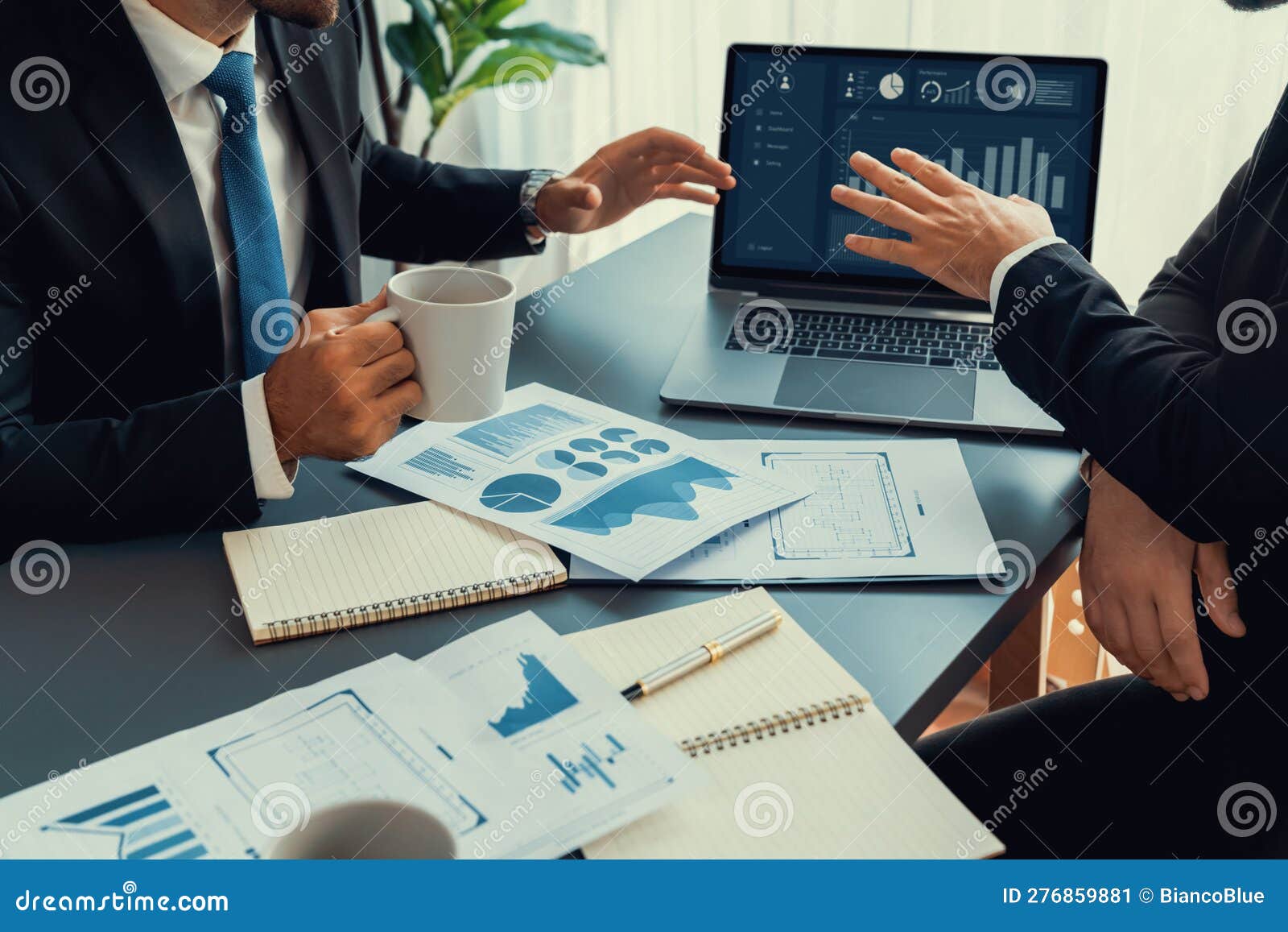 Closeup Busy Analyst Team with Coffee Discuss Financial Data on Laptop ...