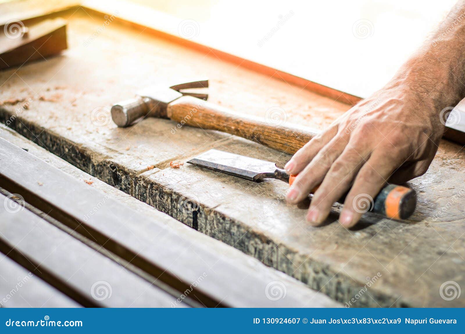 Closeup of a Carpenter Hands Working with a Chisel and Hammer on Wooden ...
